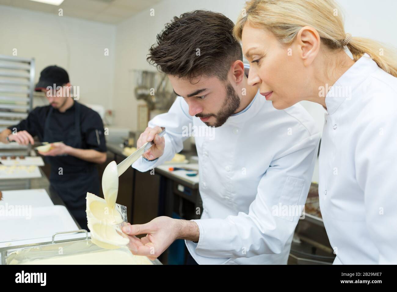 young chef making white chocolate egg using mould Stock Photo - Alamy