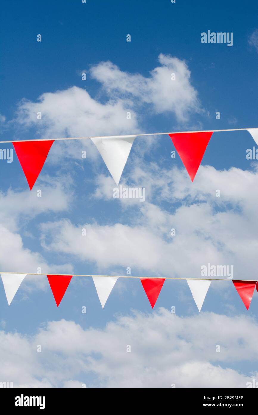 Colorful triangle bunting flags of various colors as festival concep ...
