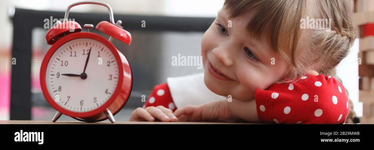 Happy child with clock Stock Photo - Alamy