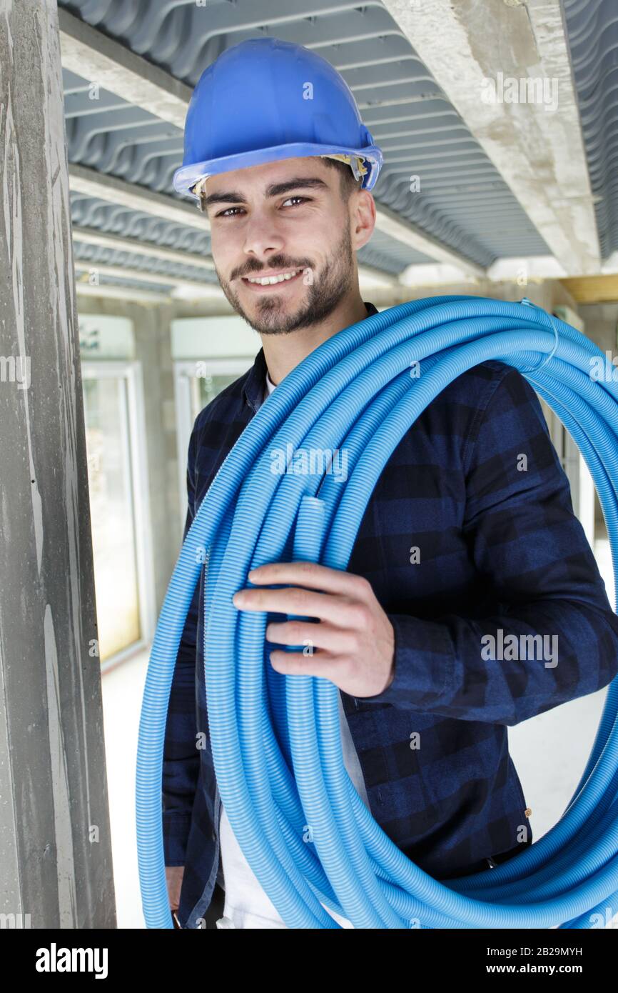 technician holding water pipes indoors Stock Photo - Alamy