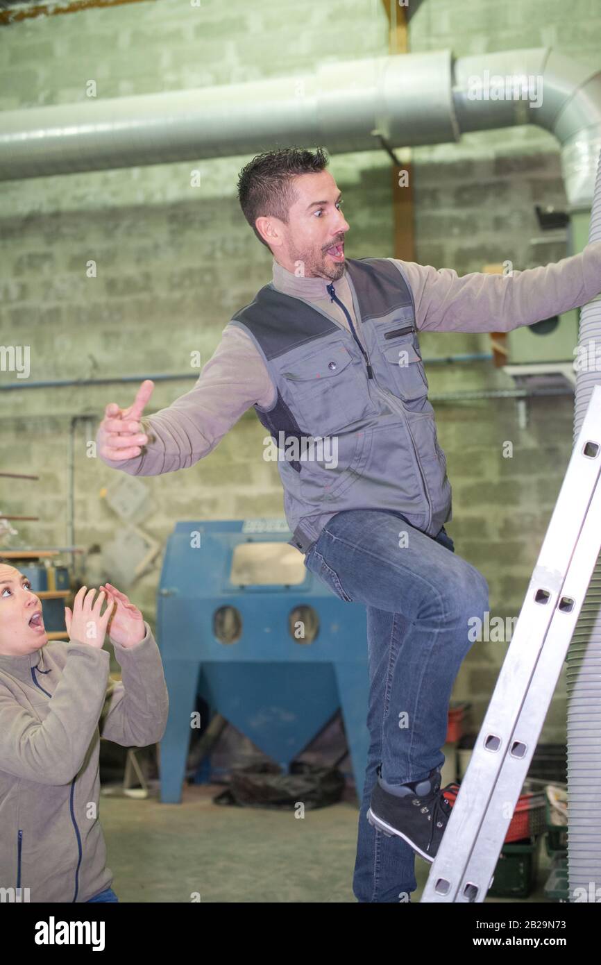 worker falling from ladder in a factory Stock Photo - Alamy