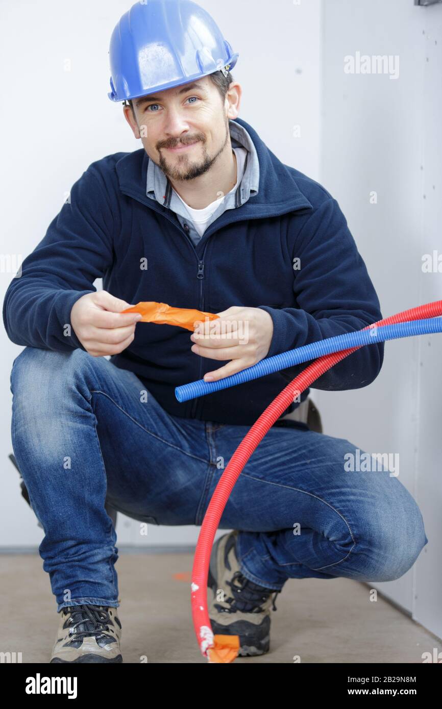 a man is working with pipes Stock Photo - Alamy