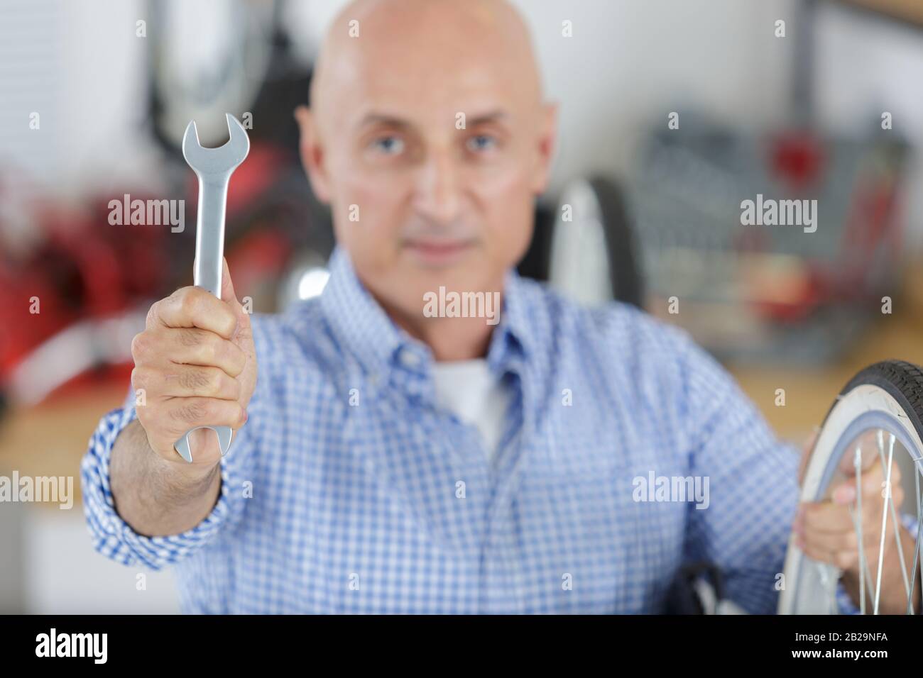 man holding a wrench Stock Photo - Alamy