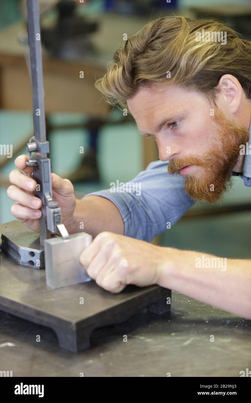 concentrated man measuring panel with metal liner Stock Photo - Alamy