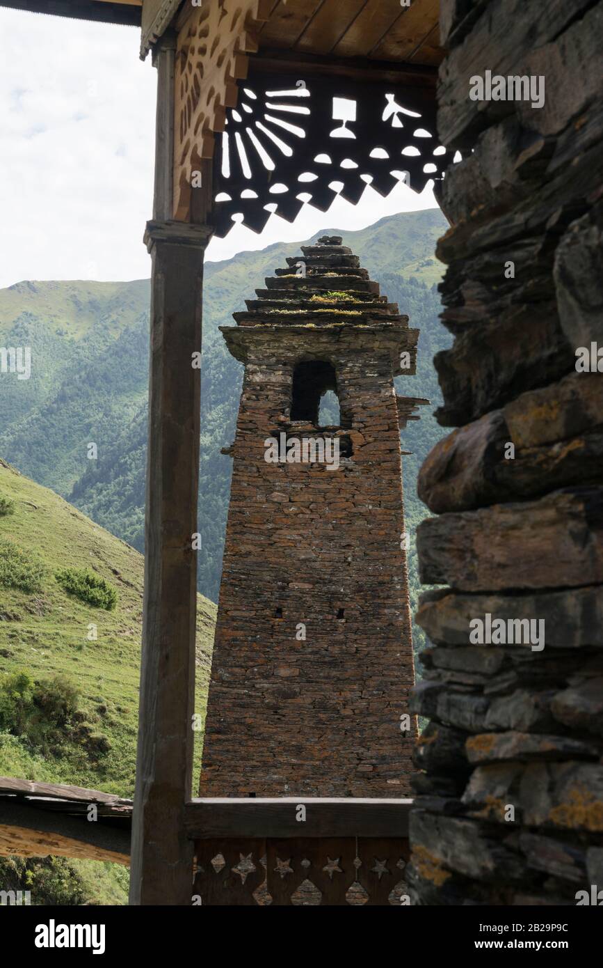 Old stone tower through wooden terrace. Architecture in mountain ...