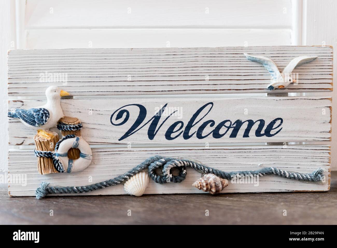 Welcome sign on antique rustic wooden sign with sea birds, Anchor and ...