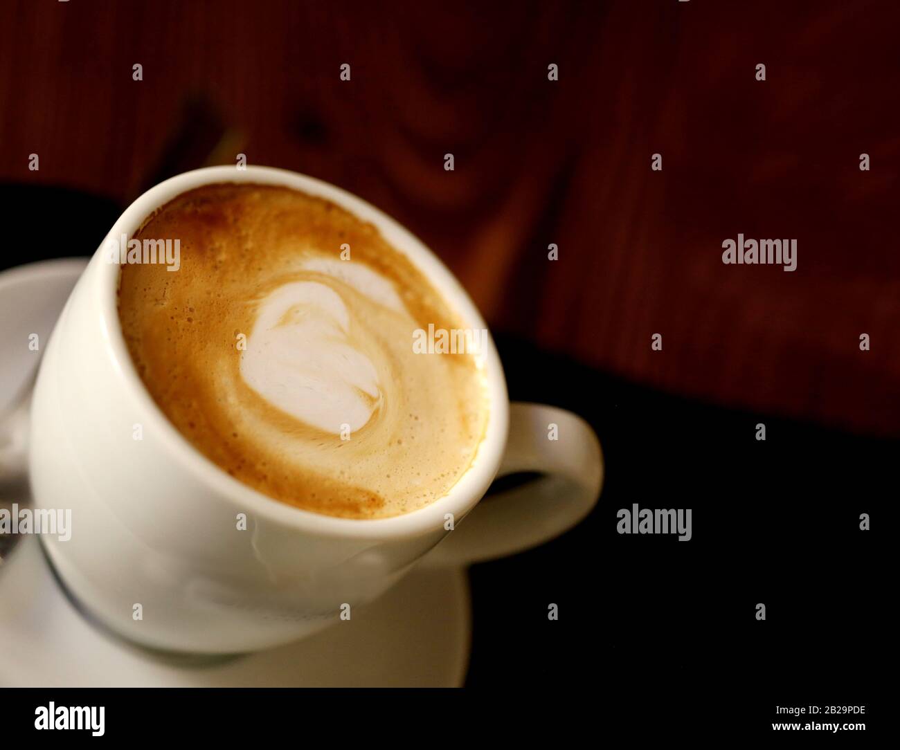 Photo of a large tasty cup of coffee with milk in a restaurant ...