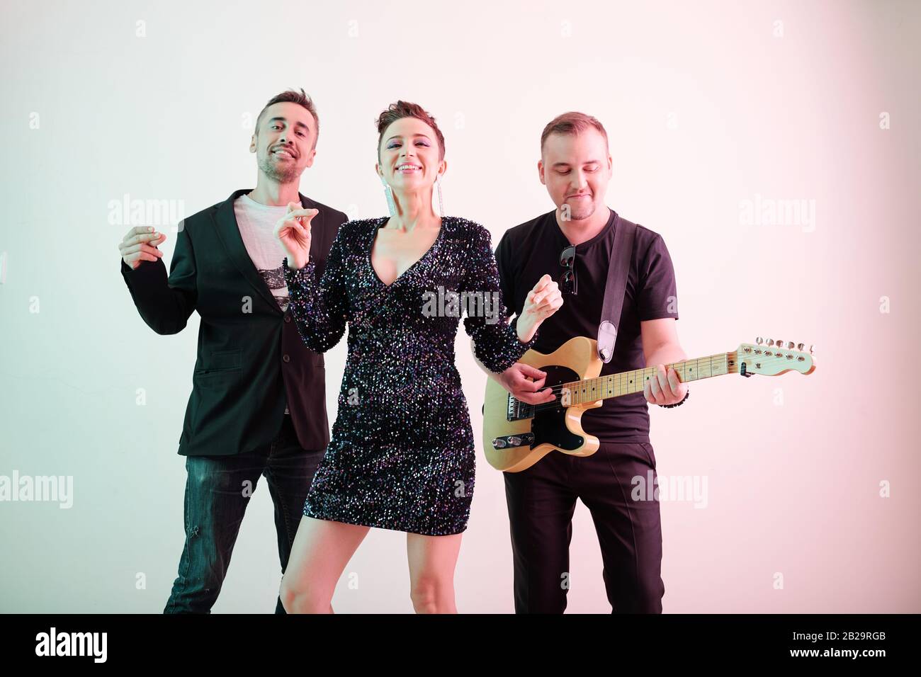 Happy music band singing and dancing when performing together Stock ...