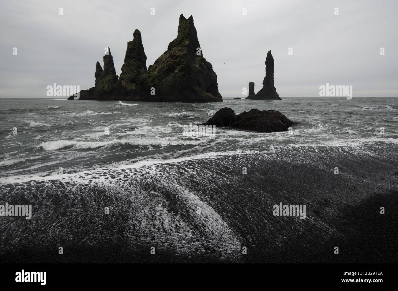 Troll's fingers rocks surrounded with sea near famous black Vik beach ...