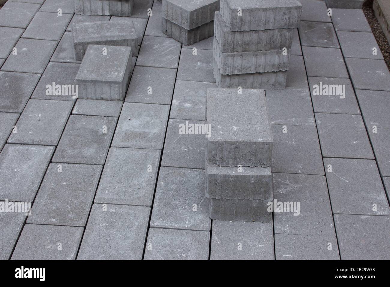 Concrete paver blocks laid beside a building, some paving stones are ...