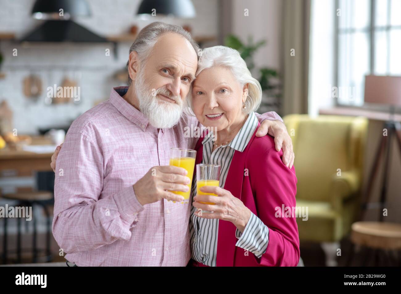 Married senior couple having orange juice and feeling good Stock Photo ...