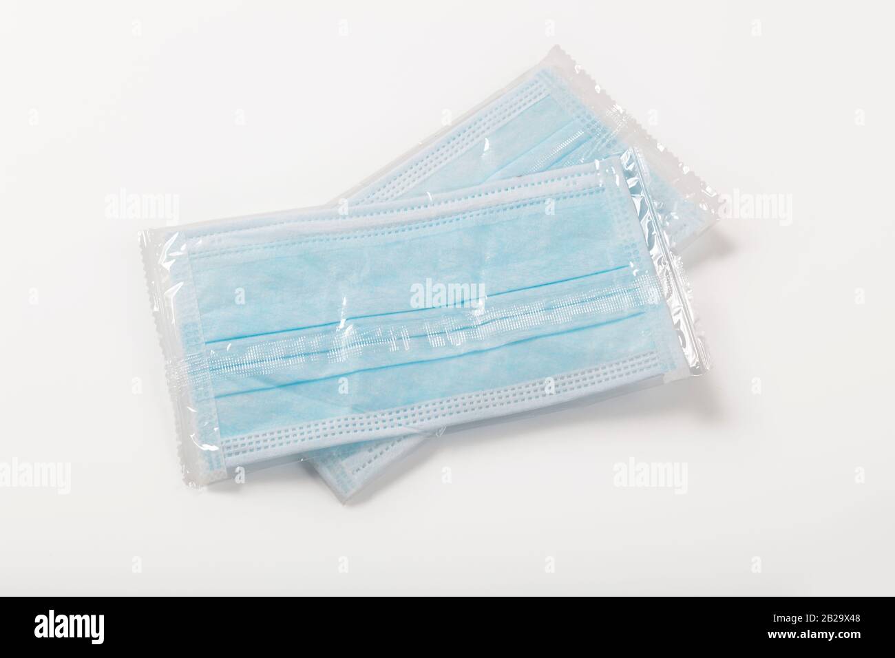 blue disposable surgical face masks with white background Stock Photo ...
