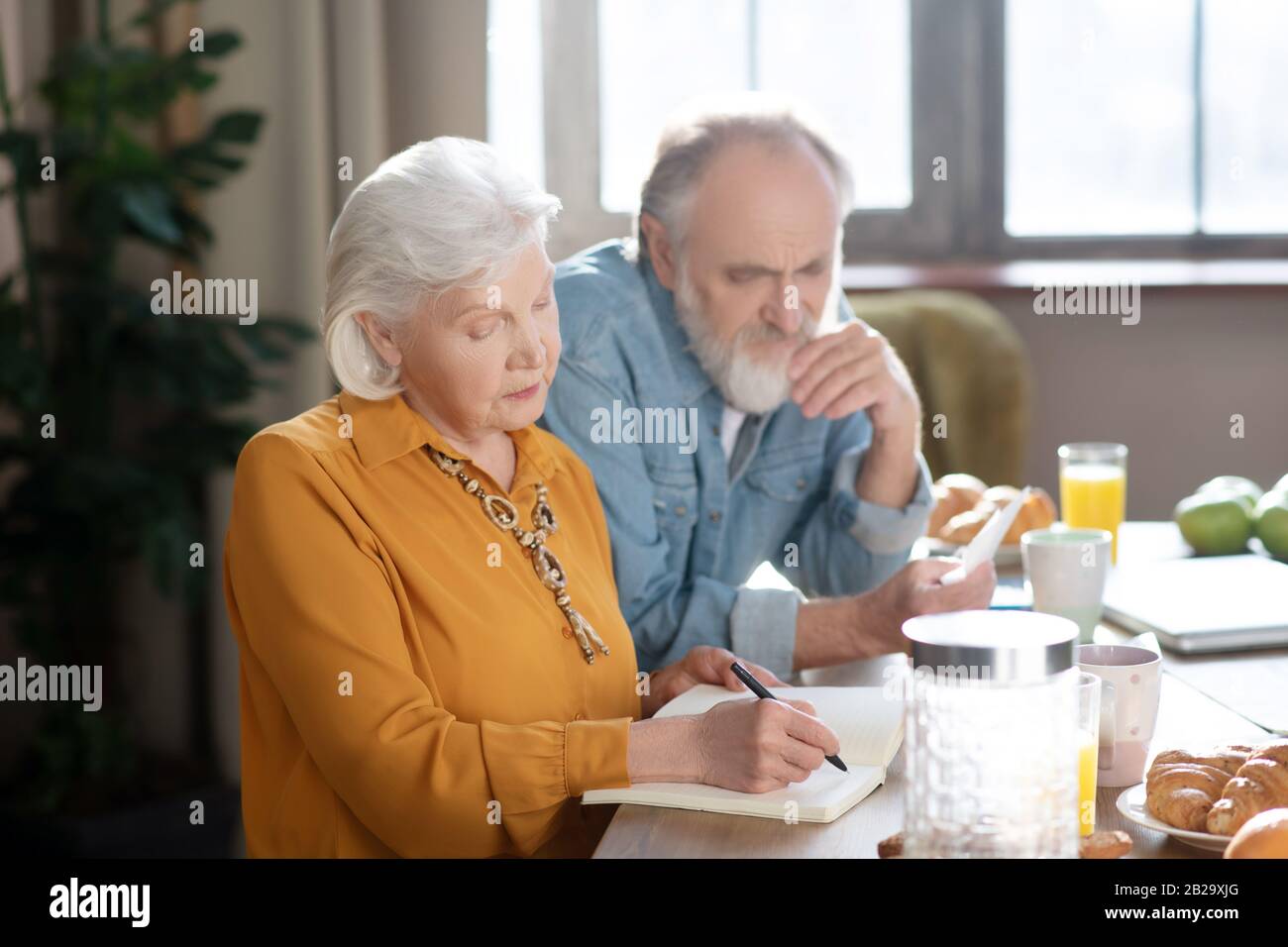 Two people making calculations hi-res stock photography and images - Alamy