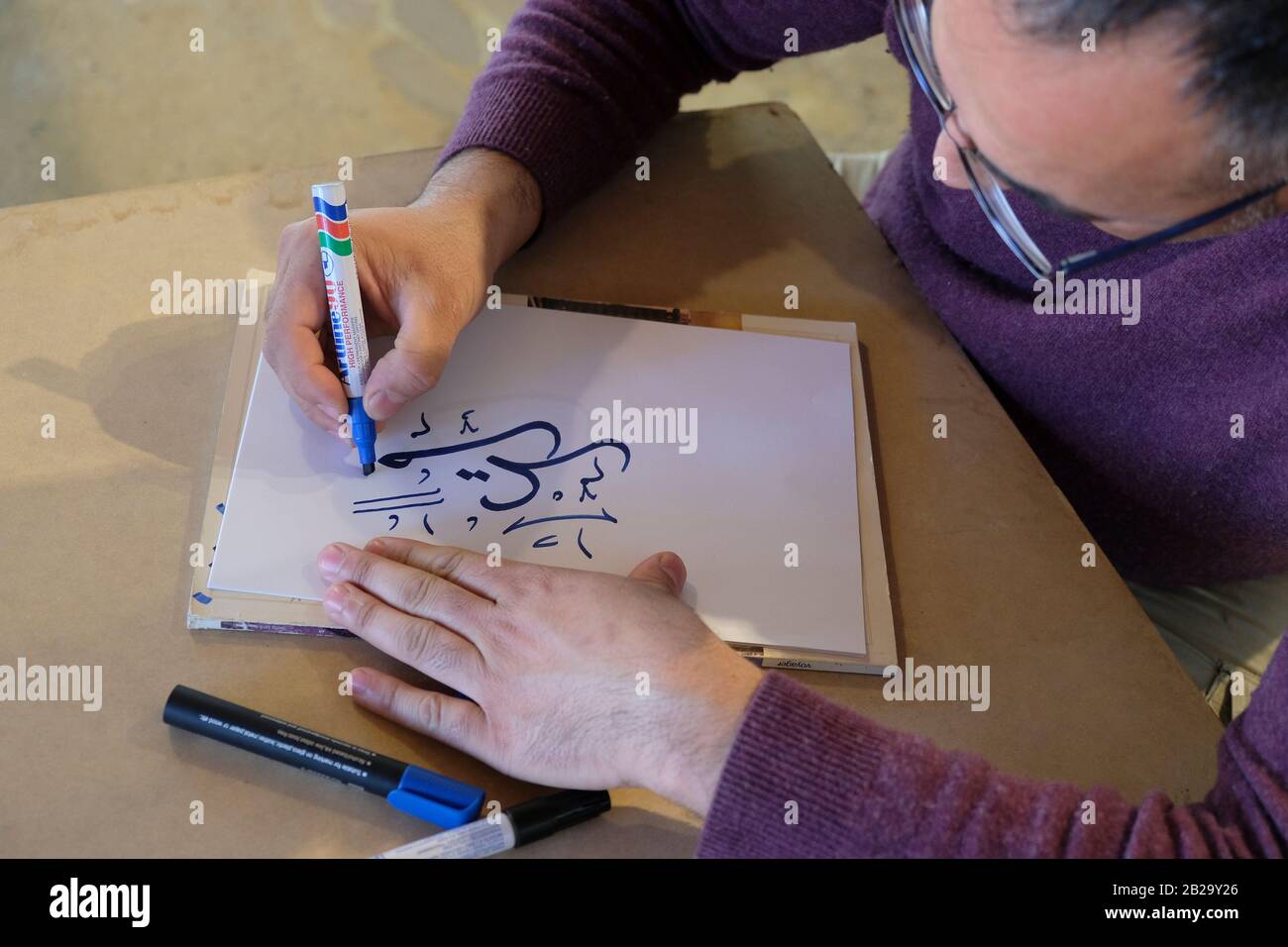 A Palestinian man writing Arabic Stock Photo - Alamy