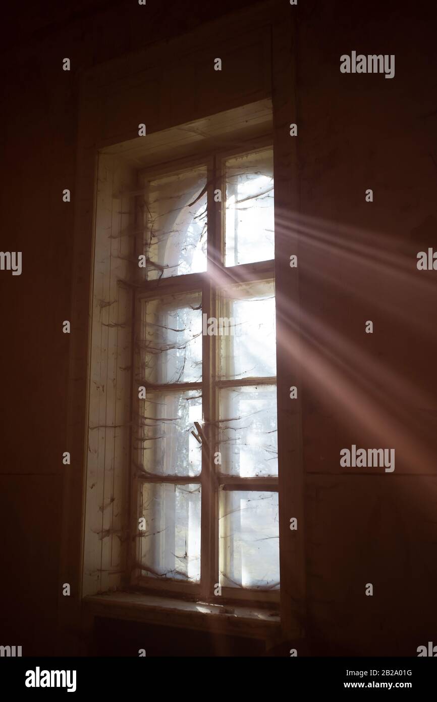 A ray of sun coming through an old window. Concept of hope Stock Photo ...