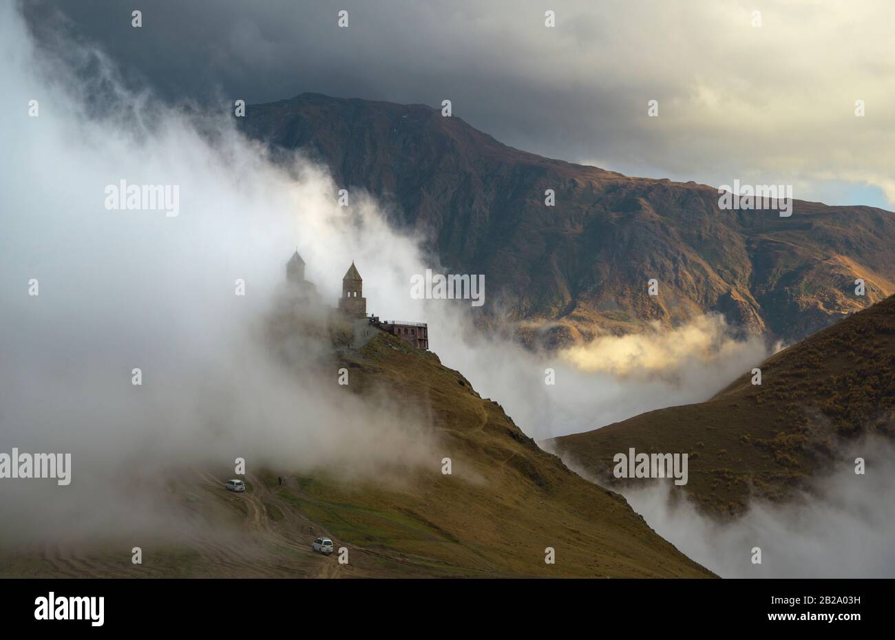 Gergeti Trinity Church (Georgia) surrounded with clouds Stock Photo - Alamy