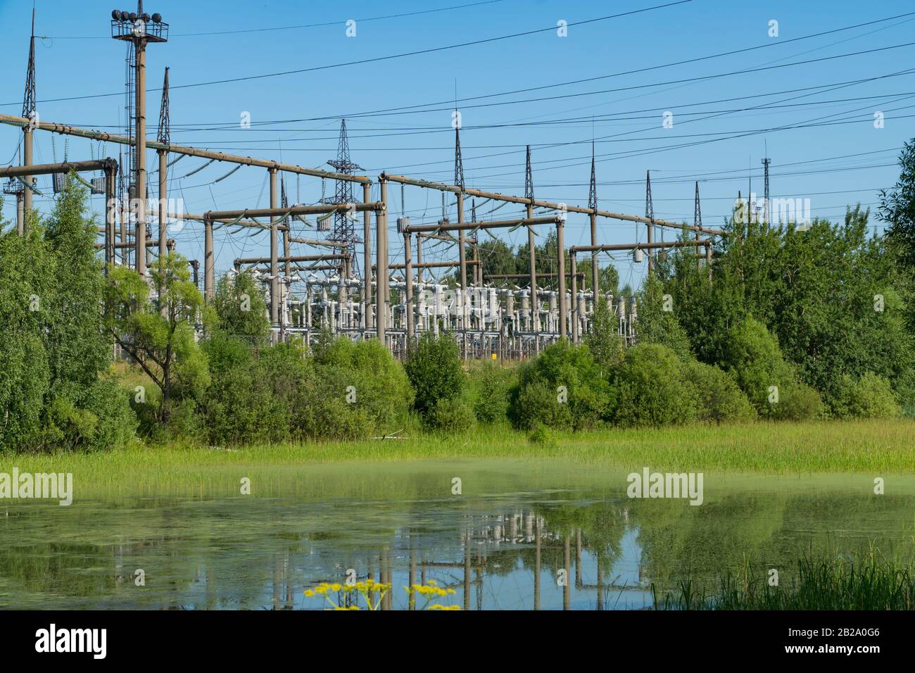 Power station near the pond. Power lines Stock Photo - Alamy