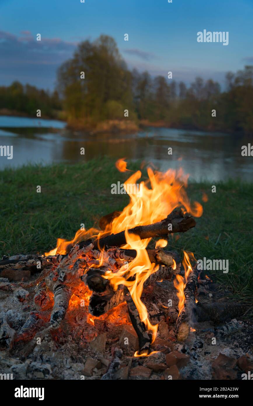 Fire (campfire) against landscape with river background Stock Photo - Alamy