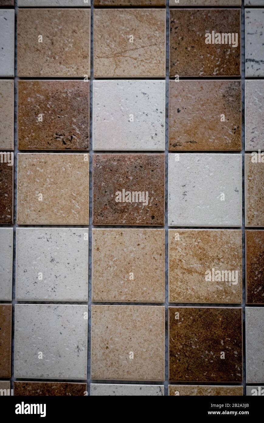 Brown ceramic mosaic on the wall as background Stock Photo - Alamy