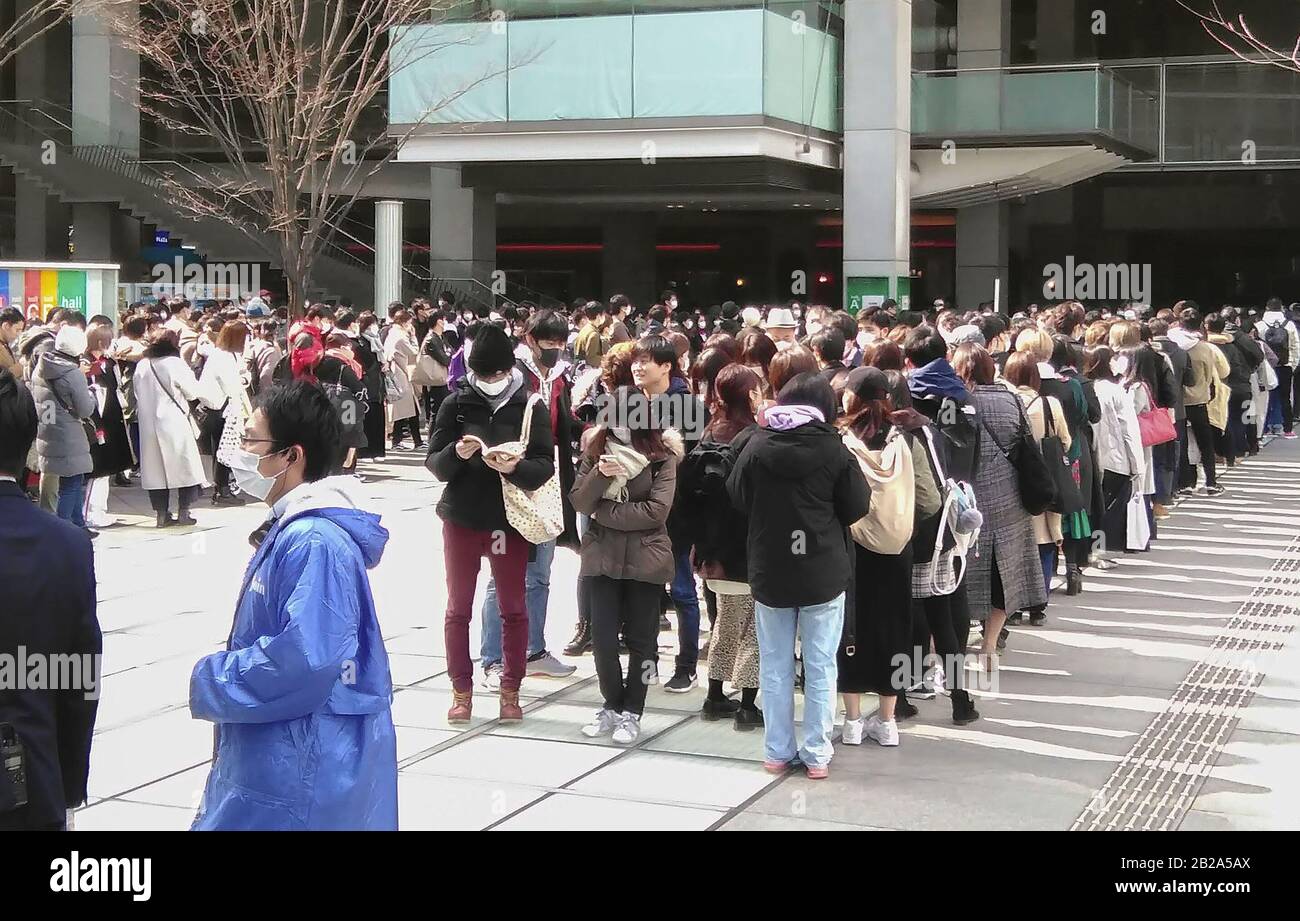 People line up for official merchandise ahead of a concert by Japanese ...