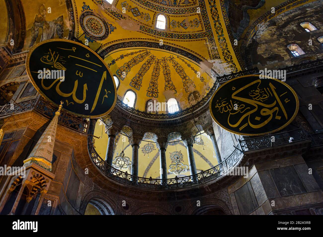 Ornate dome and painted arches, with later added Islamic banners ...