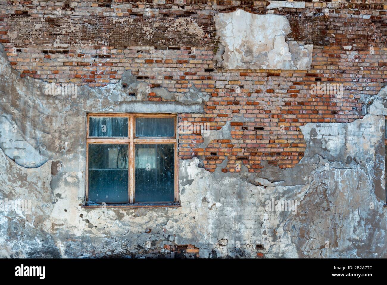 Texture of an old building with a window. Background ruined plaster ...