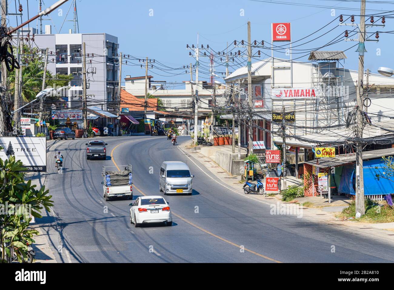 Traffic on the road with messy and untidy electrical cables hanging ...