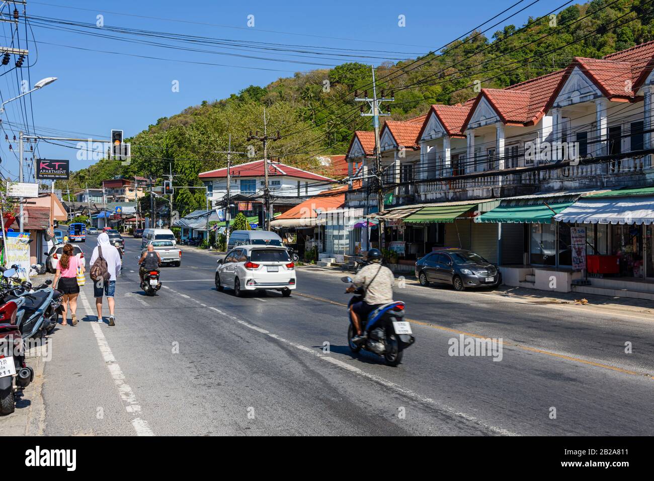 Traffic on the road with messy and untidy electrical cables hanging ...