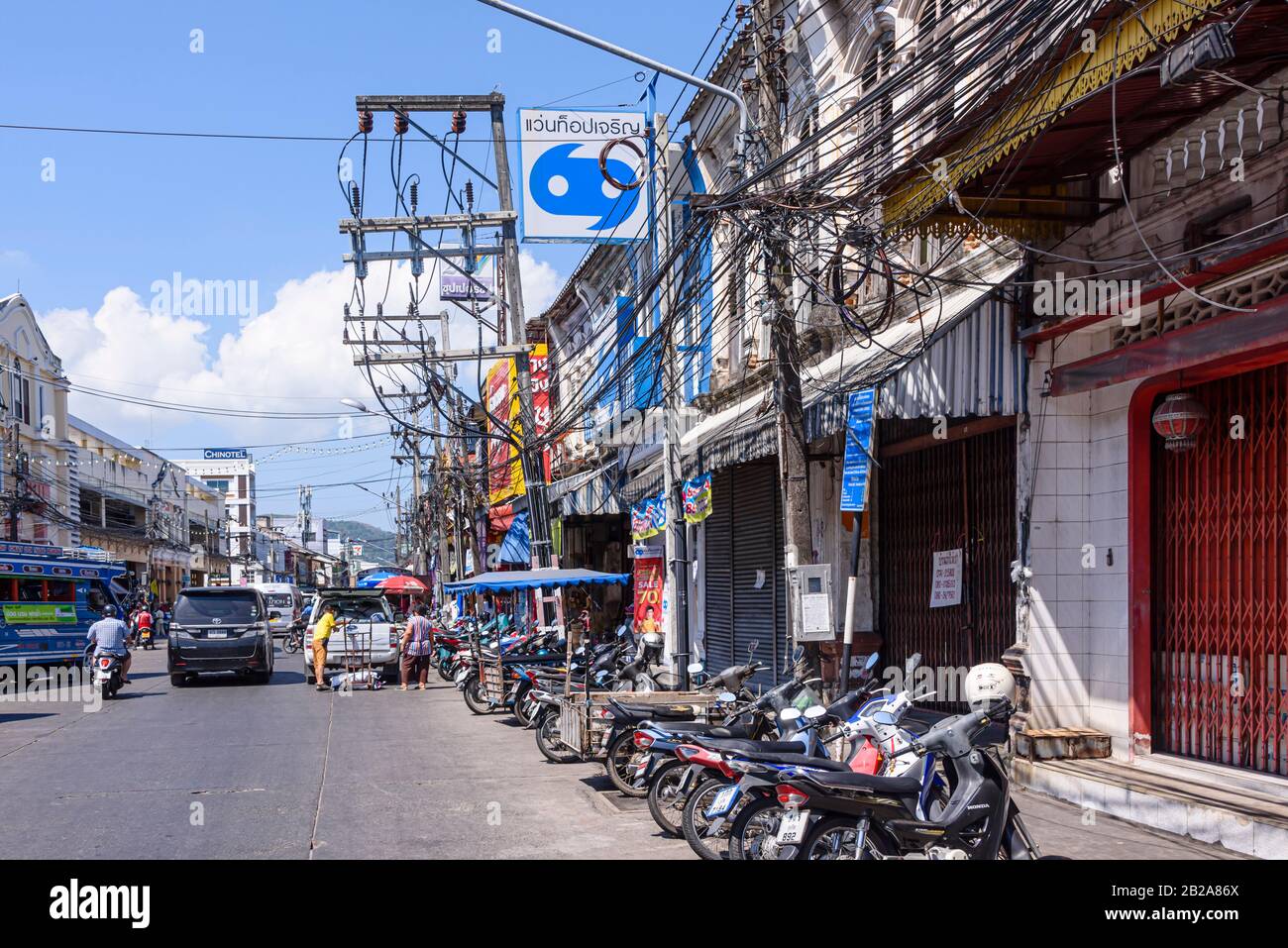 Messy and untidy electrical cables hanging from an electricity pole in ...