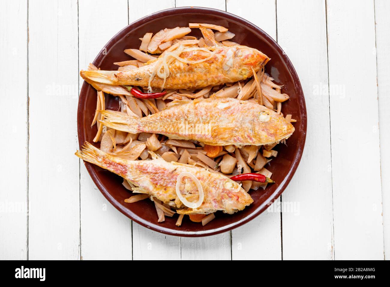 Spicy mullet fish fried with horseradish roots and jerusalem artichoke ...