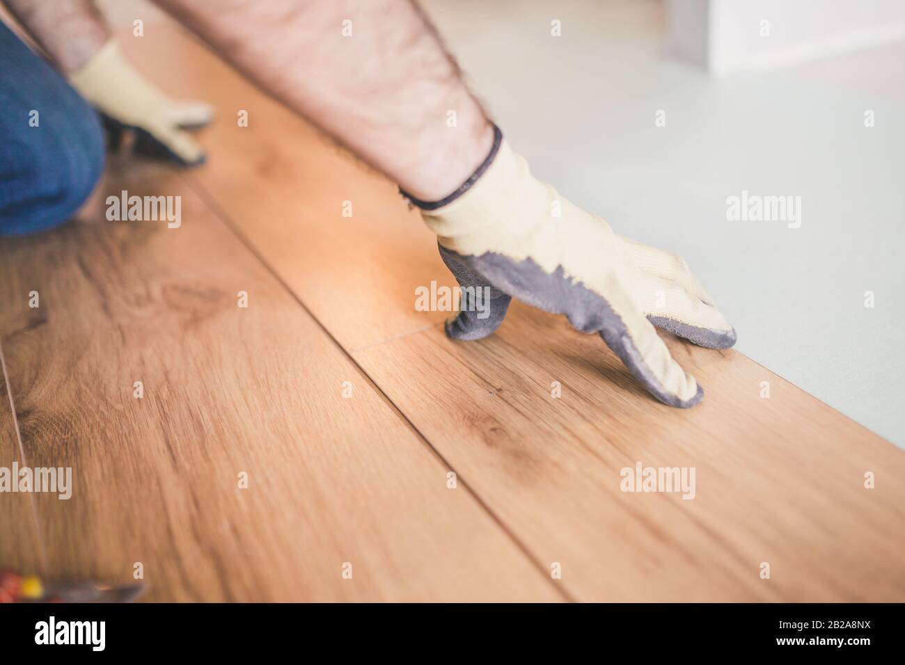 Professional flooring installation - laying a new laminate with a ...
