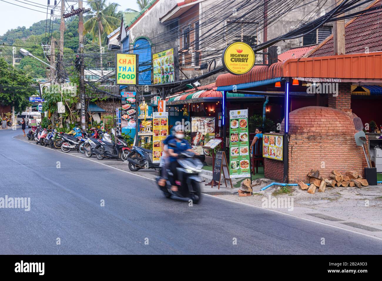 Traffic on a typical street in Kata village, Phuket, Thailand Stock ...