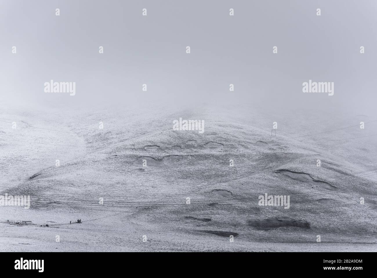 telegraph pole, electric wire and mountain which covered with snow ...