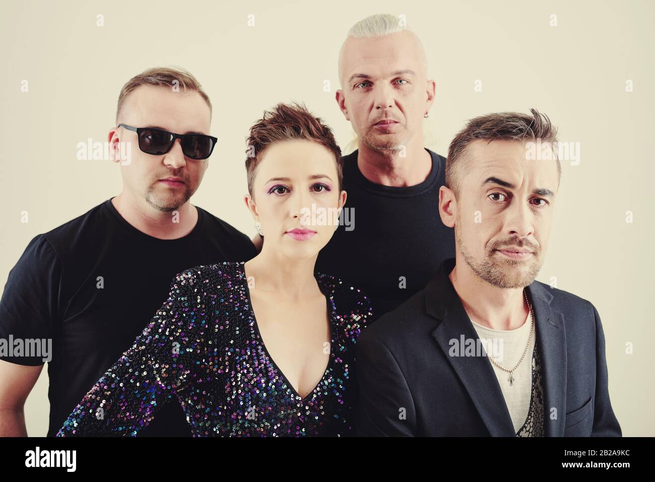 Singers, guitar player and drummer posing for music band album cover ...