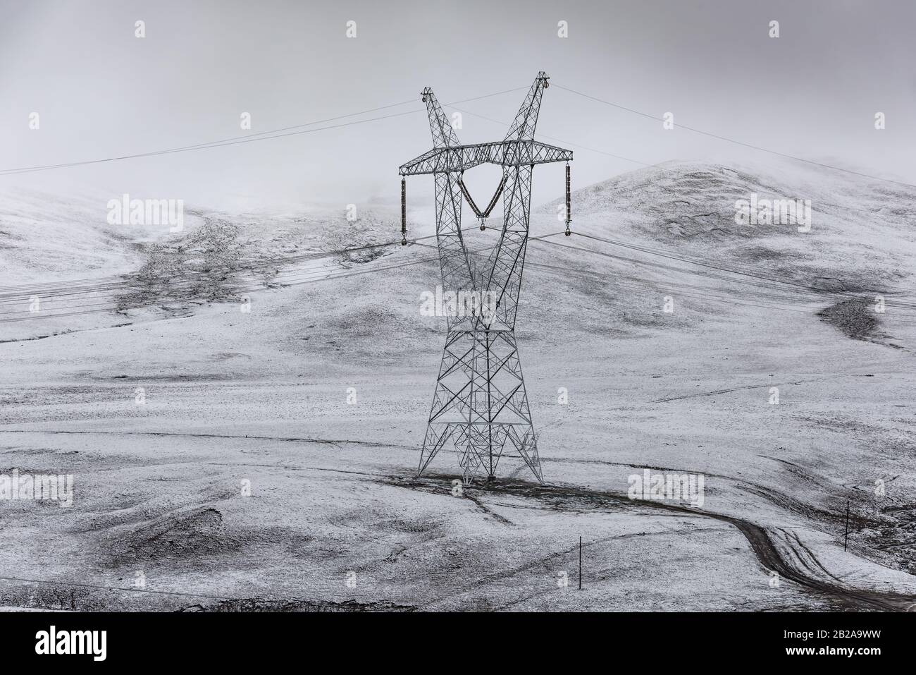 electricity pylon on a mountain which covered with snow Stock Photo - Alamy
