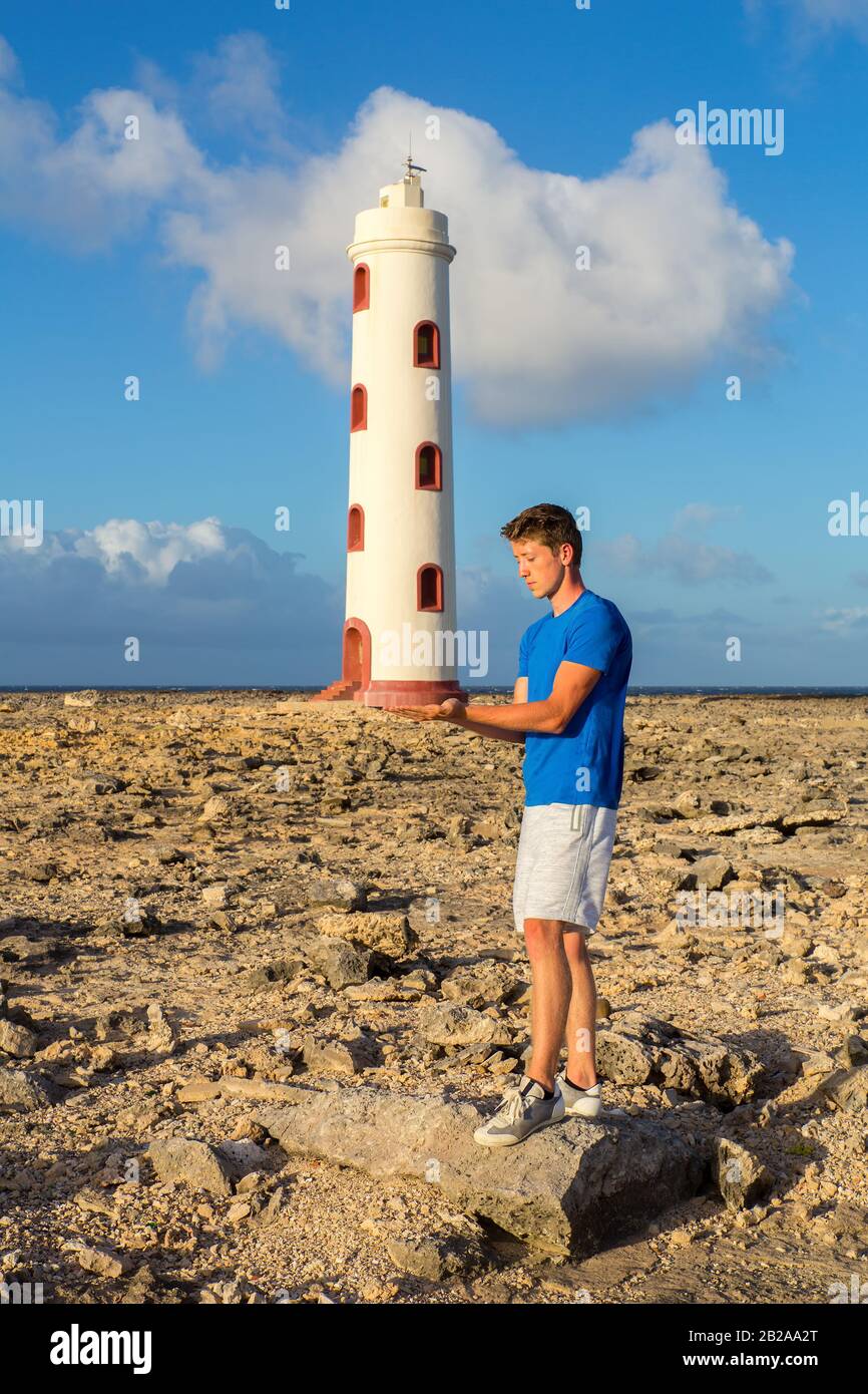 Lighthouse and young dutch man at rocky coast Stock Photo - Alamy