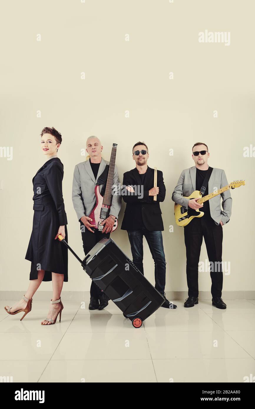 Creative band members with music instruments and speaker ready to ...