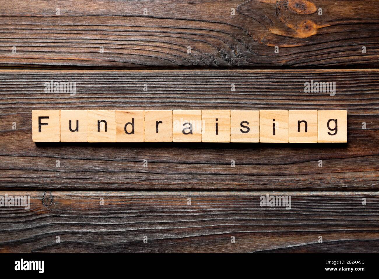 fundraising word written on wood block. fundraising text on table ...
