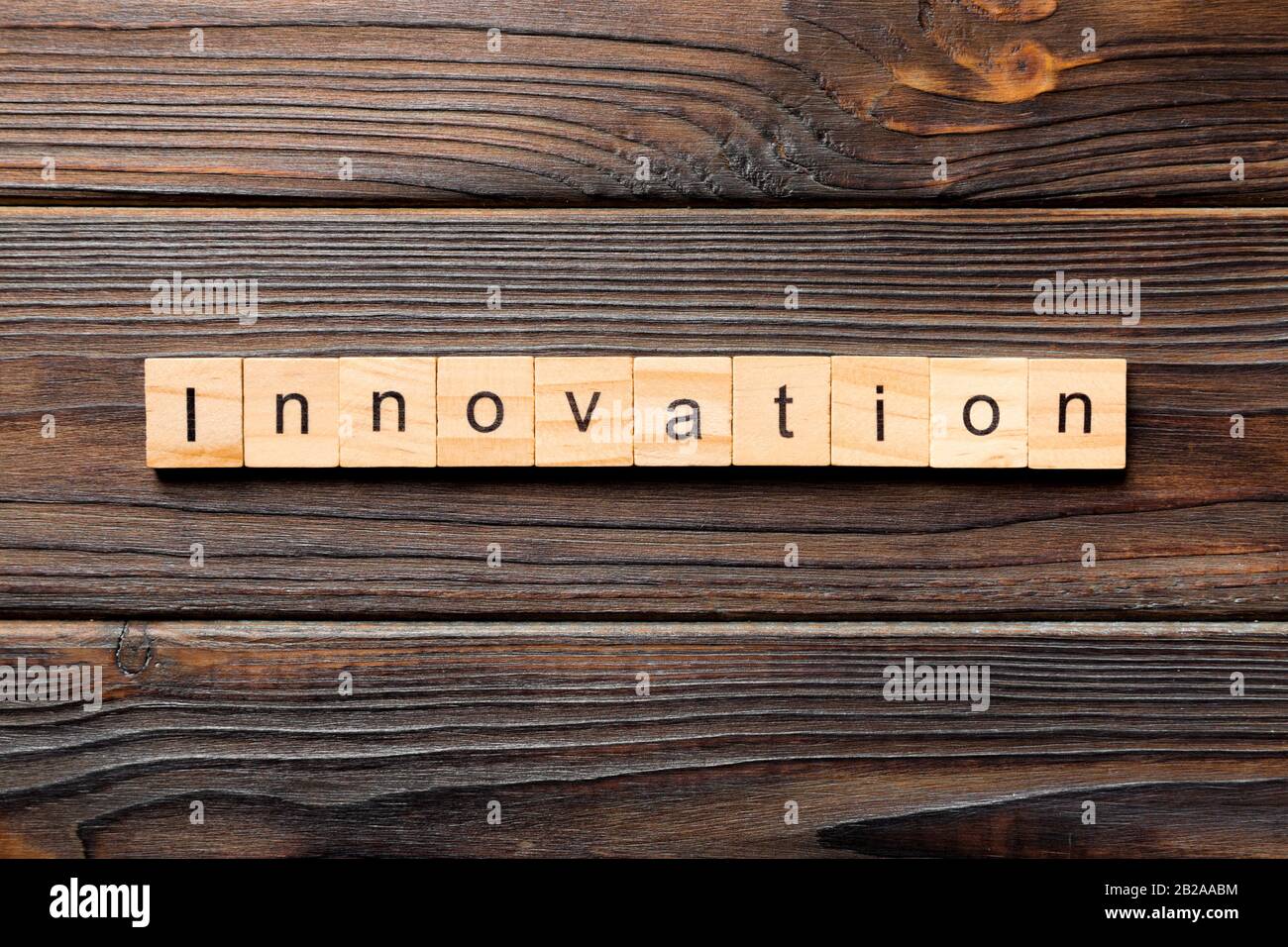 INNOVATION word written on wood block. INNOVATION text on table ...