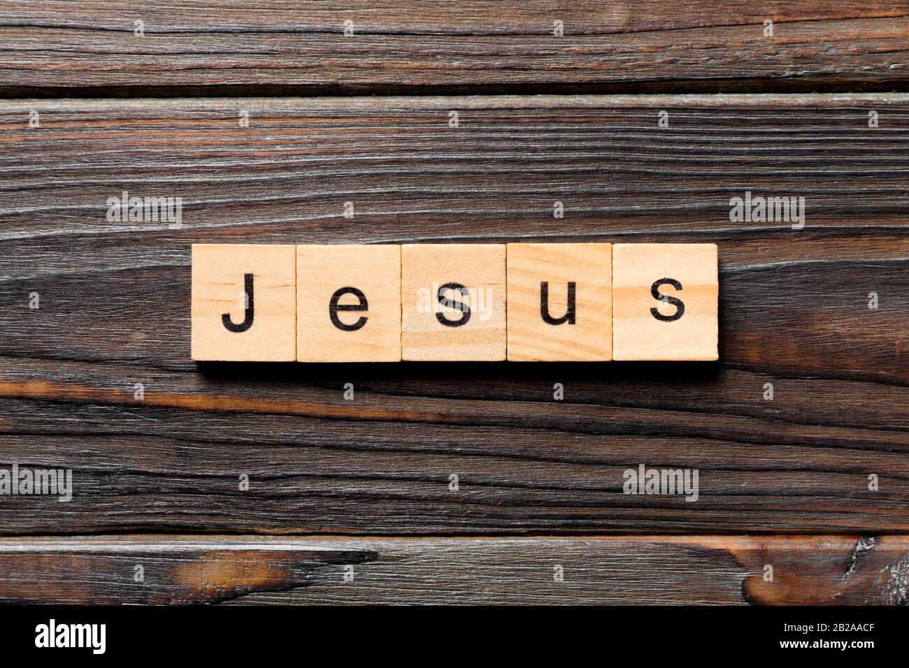 Jesus word written on wood block. Jesus text on table, concept Stock ...
