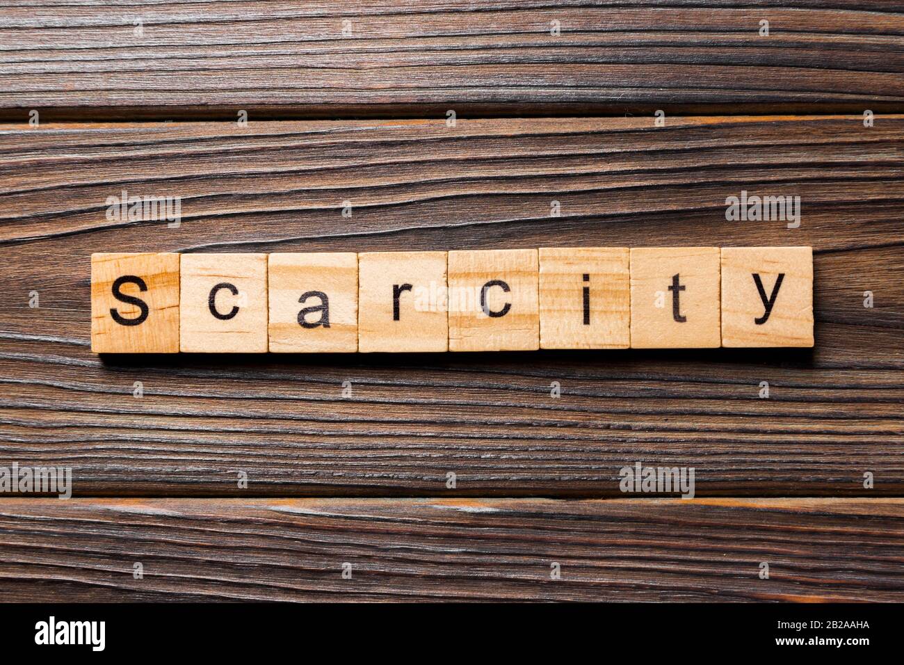 scarcity word written on wood block. scarcity text on wooden table for ...