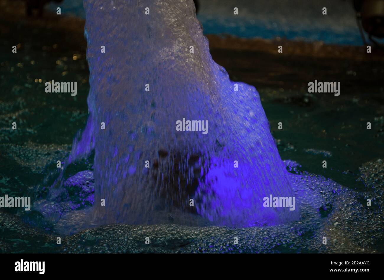 Blurred water background. Backlit water jet in the fountain Stock Photo ...