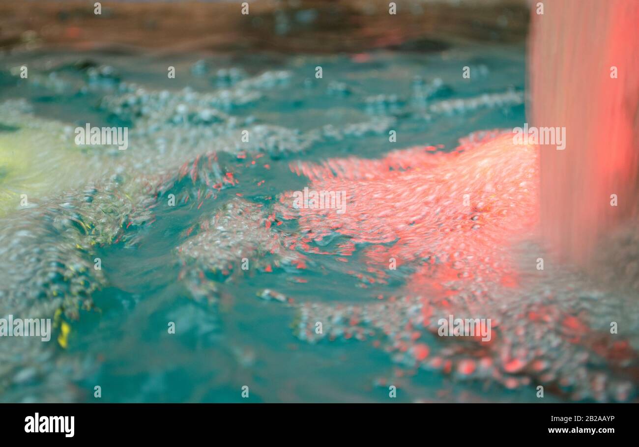 Blurred water background. Backlit water jet in the fountain Stock Photo ...