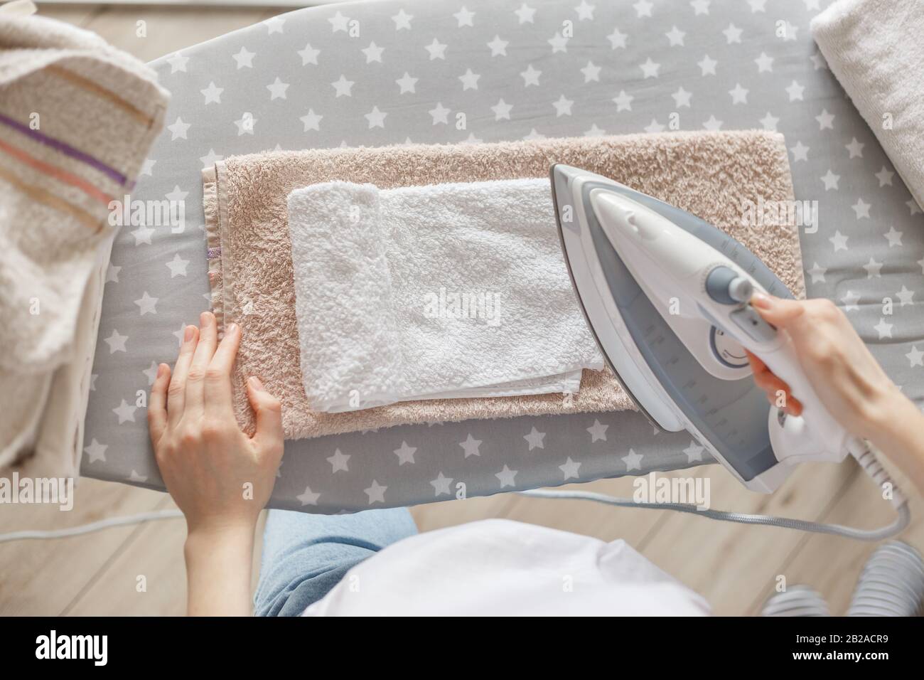 Woman ironing white cloth, top view Stock Photo - Alamy