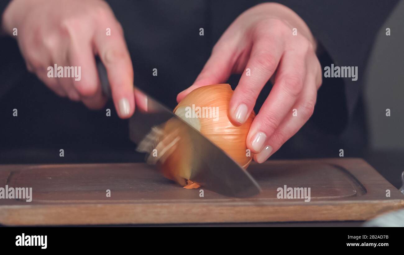 Step by step. Dicing yellow onion on a wood cutting board Stock Photo ...