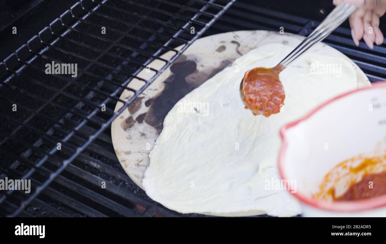 Cooking pizza on outdoor gas grill Stock Photo - Alamy