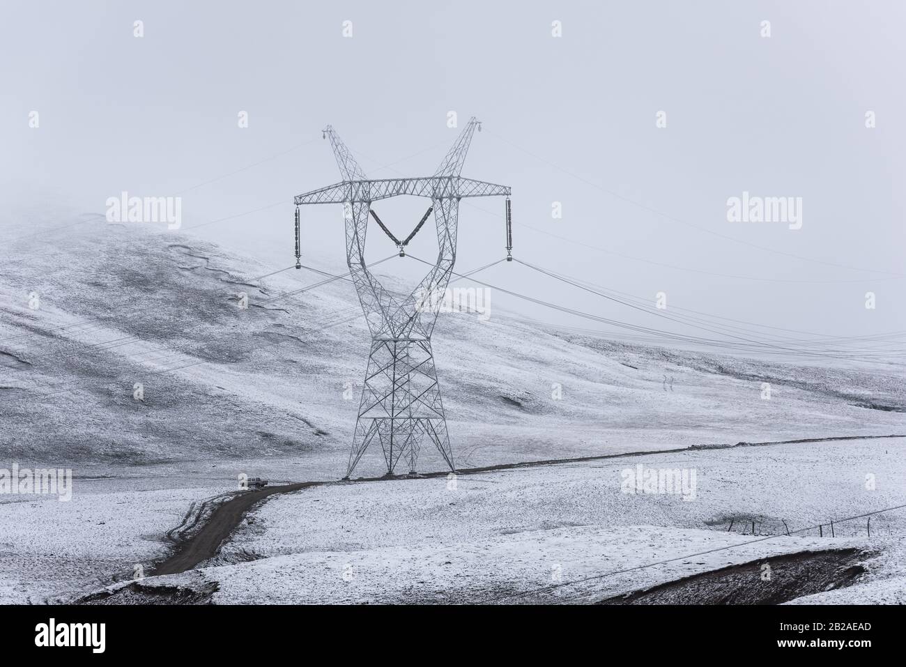 electricity pylon on a mountain which covered with snow Stock Photo - Alamy