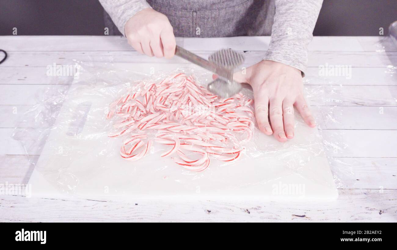 Step by step. Breaking candy cane candies into small pieces Stock Photo ...