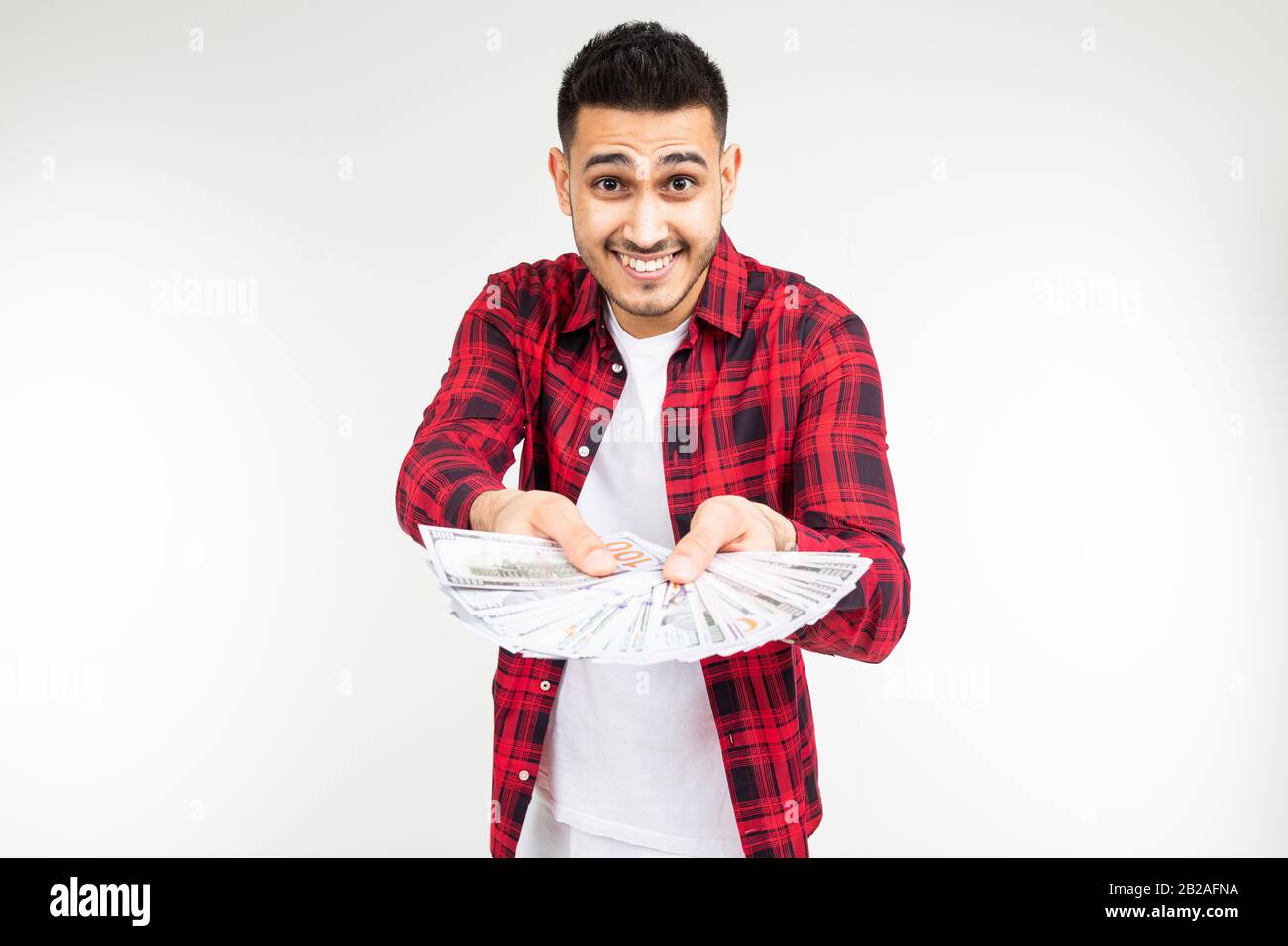 joyful man boasting a prize holding out money on a white background ...