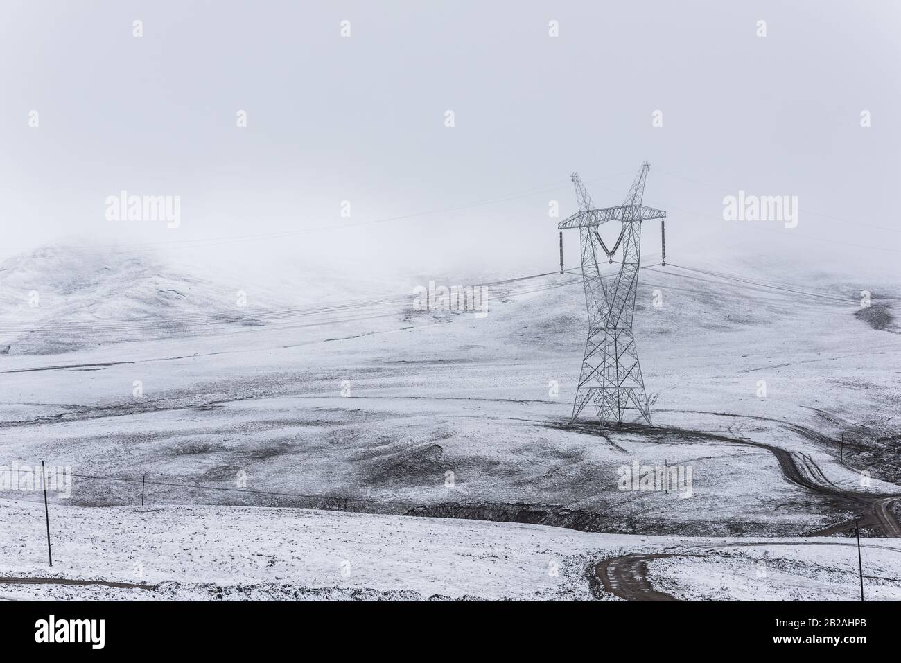 electricity pylon on a mountain which covered with snow Stock Photo - Alamy